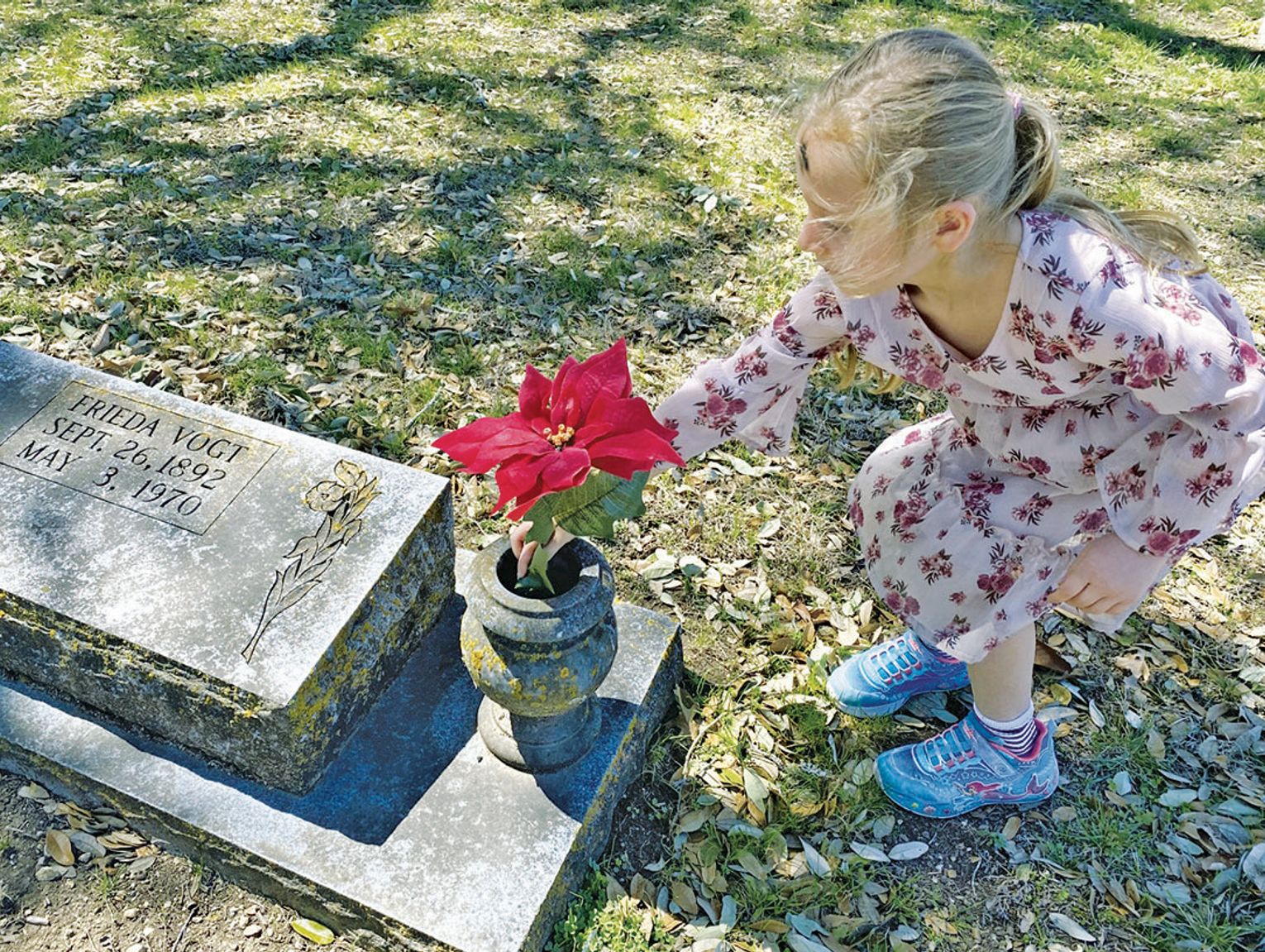 Kindergarteners tidy up wind-blown cemetery
